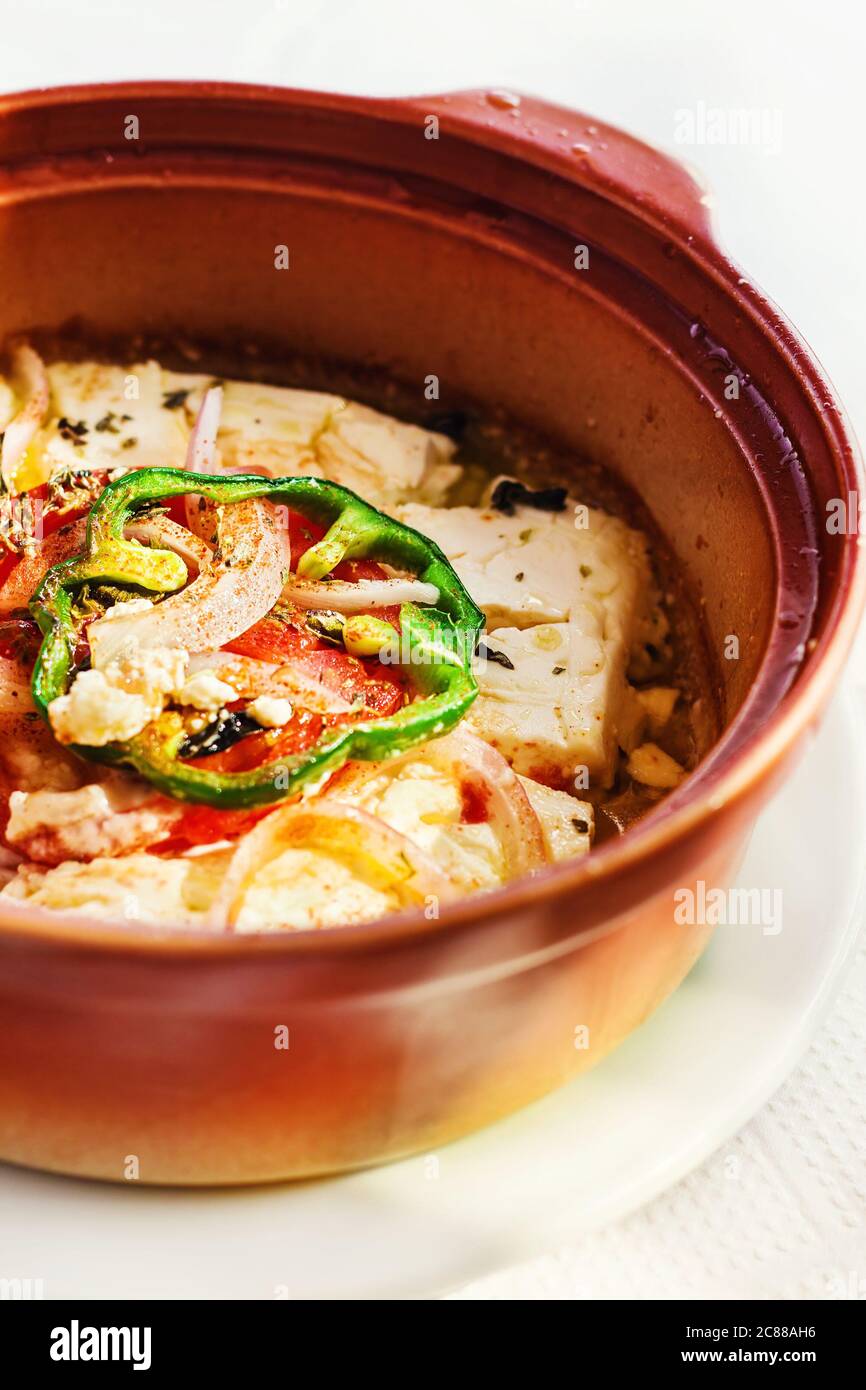 Traditional Greek oven baked feta cheese with herbs and veggies ...