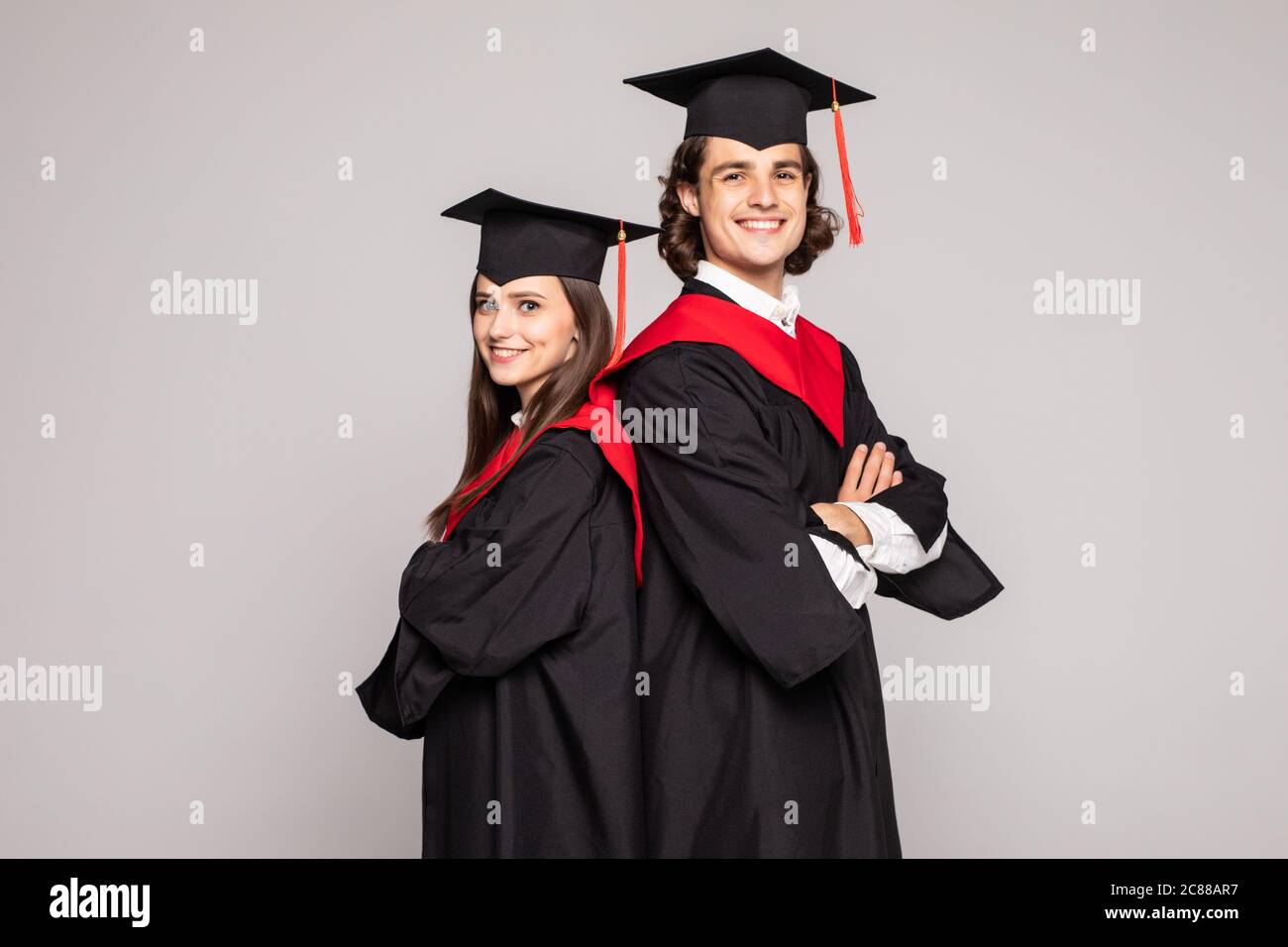 Portrait of two happy graduating students over white background Stock ...