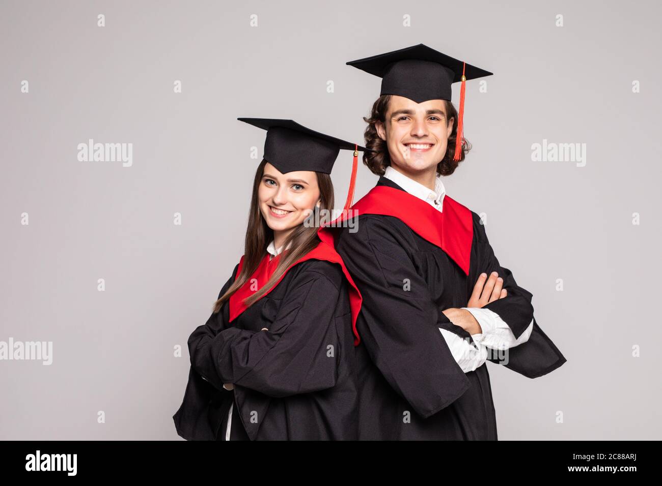 Portrait of two happy graduating students over white background Stock ...