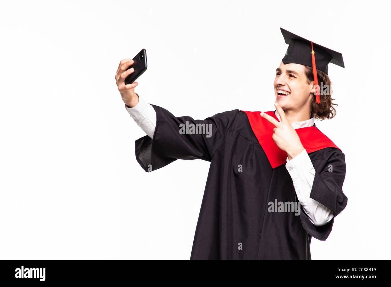 College graduate taking a selfie with cell phone holding a diploma ...
