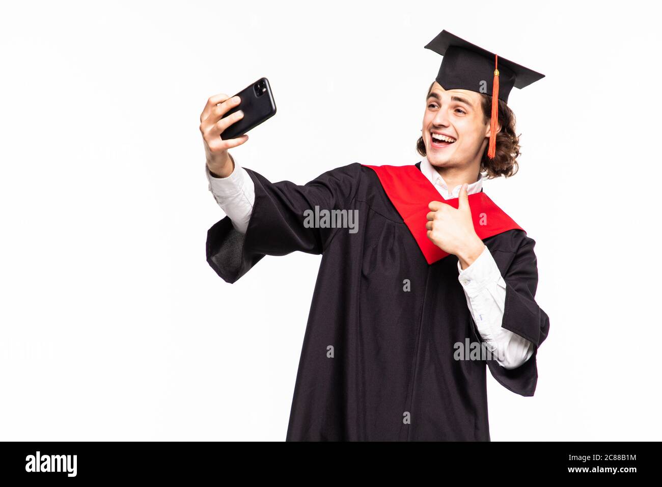 College graduate taking a selfie with cell phone holding a diploma ...