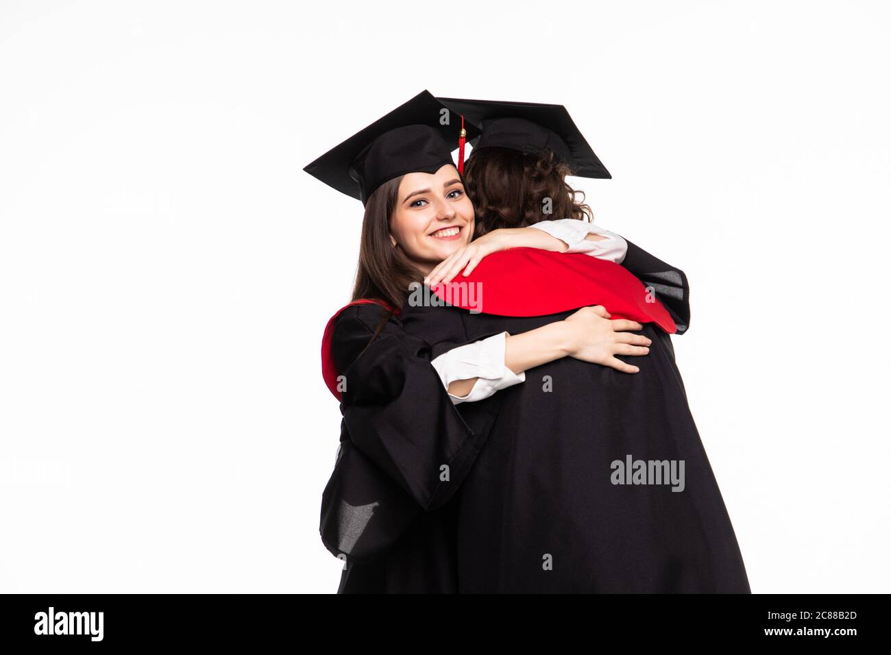 Happy graduated young students couple hugging Stock Photo - Alamy