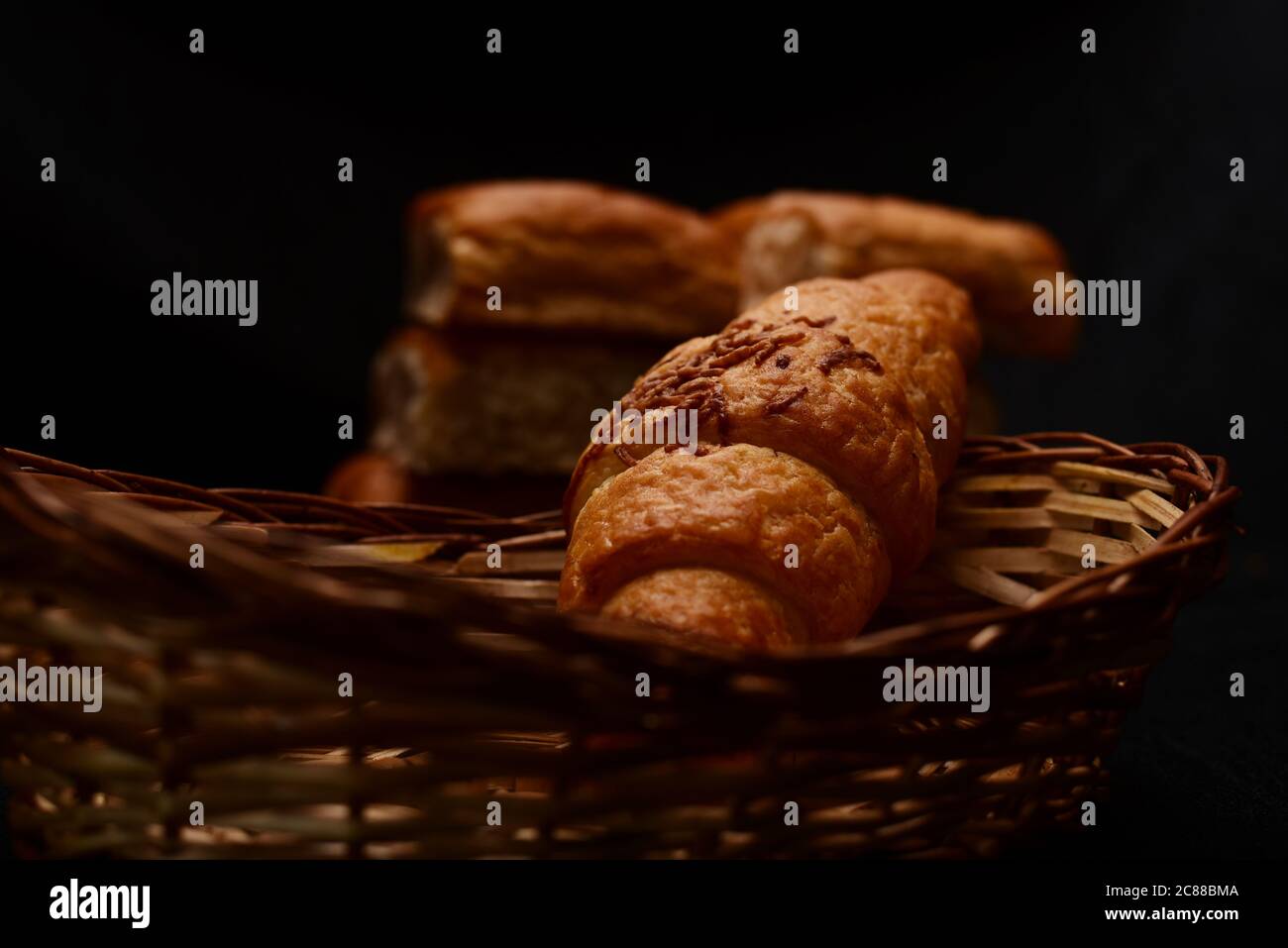 bread roll in wicker basket isolated black background. bakery ...
