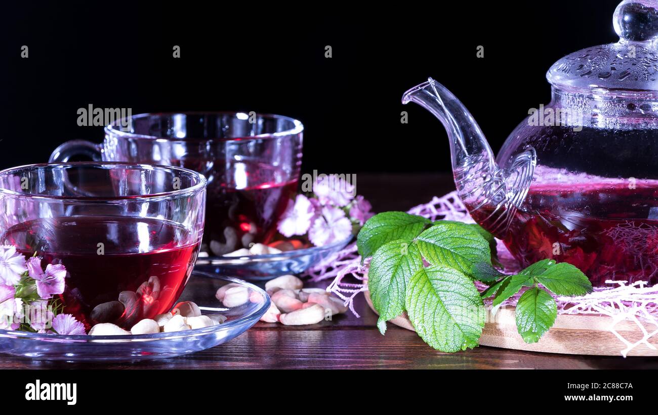 Hibiscus Red tea mug with carnation flowers close-up horizontal photo ...