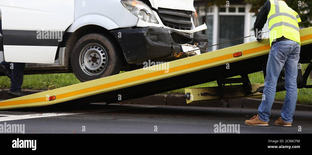 Crashed minibus is loaded onto tow truck after an accident Stock Photo ...