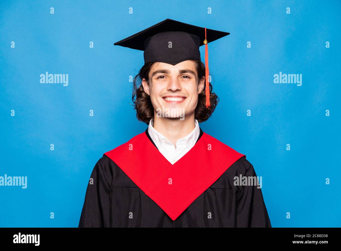 Graduate Man Holding Degree Isolated On Blue Background Stock Photo - Alamy