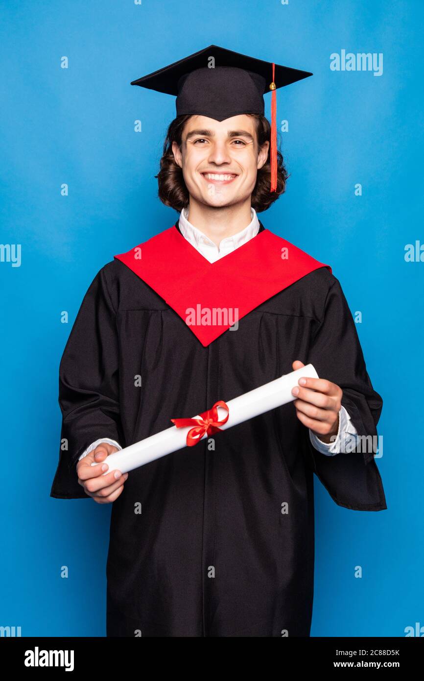 Graduate Man Holding Degree Isolated On Blue Background Stock Photo - Alamy