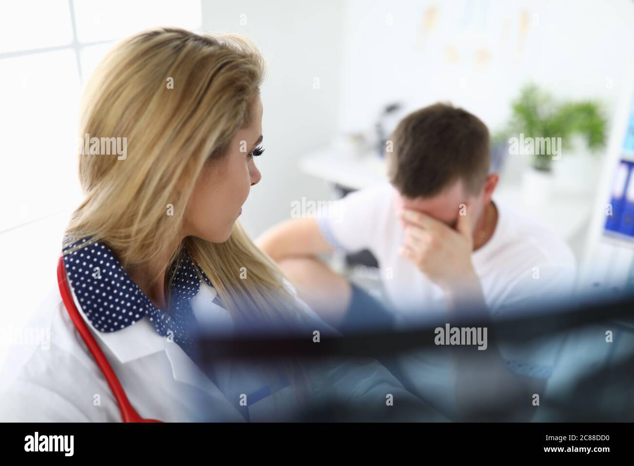 Male patient with bowed head in doctor's office Stock Photo - Alamy