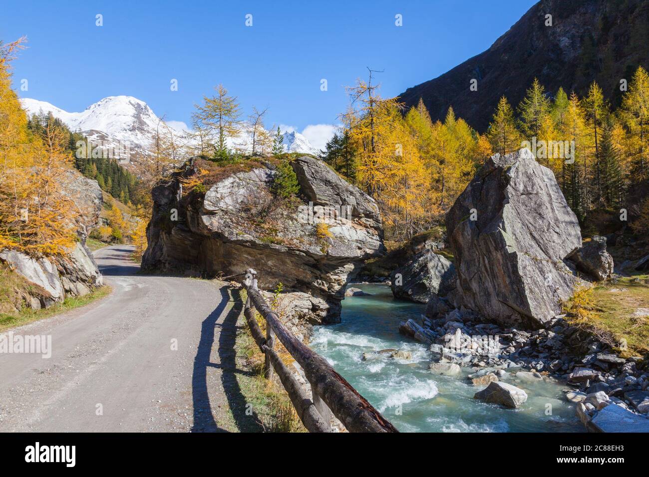 Country road through the valley alongside the river Stock Photo - Alamy