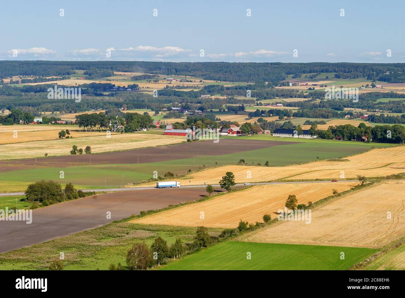 Rural view with fields and a road with traffic Stock Photo - Alamy