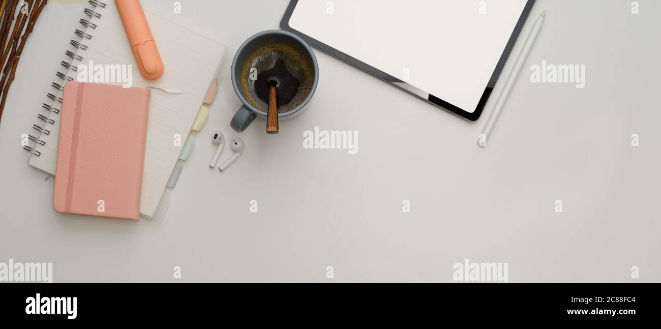 Top view of study table with mock up tablet, stationery, coffee cup and ...