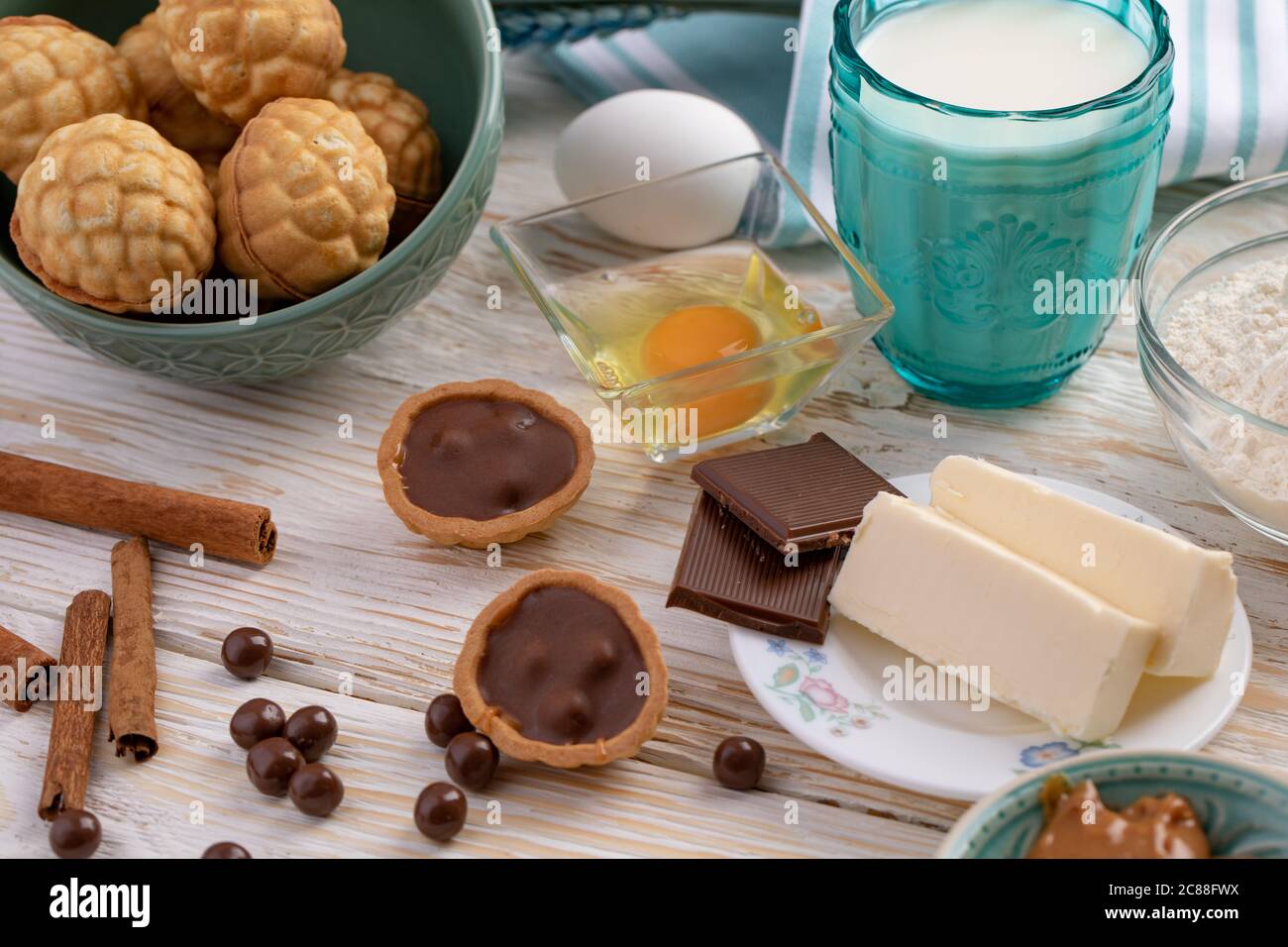 Ingredients for baking sweet cake with chocolate and nuts. egg, milk ...