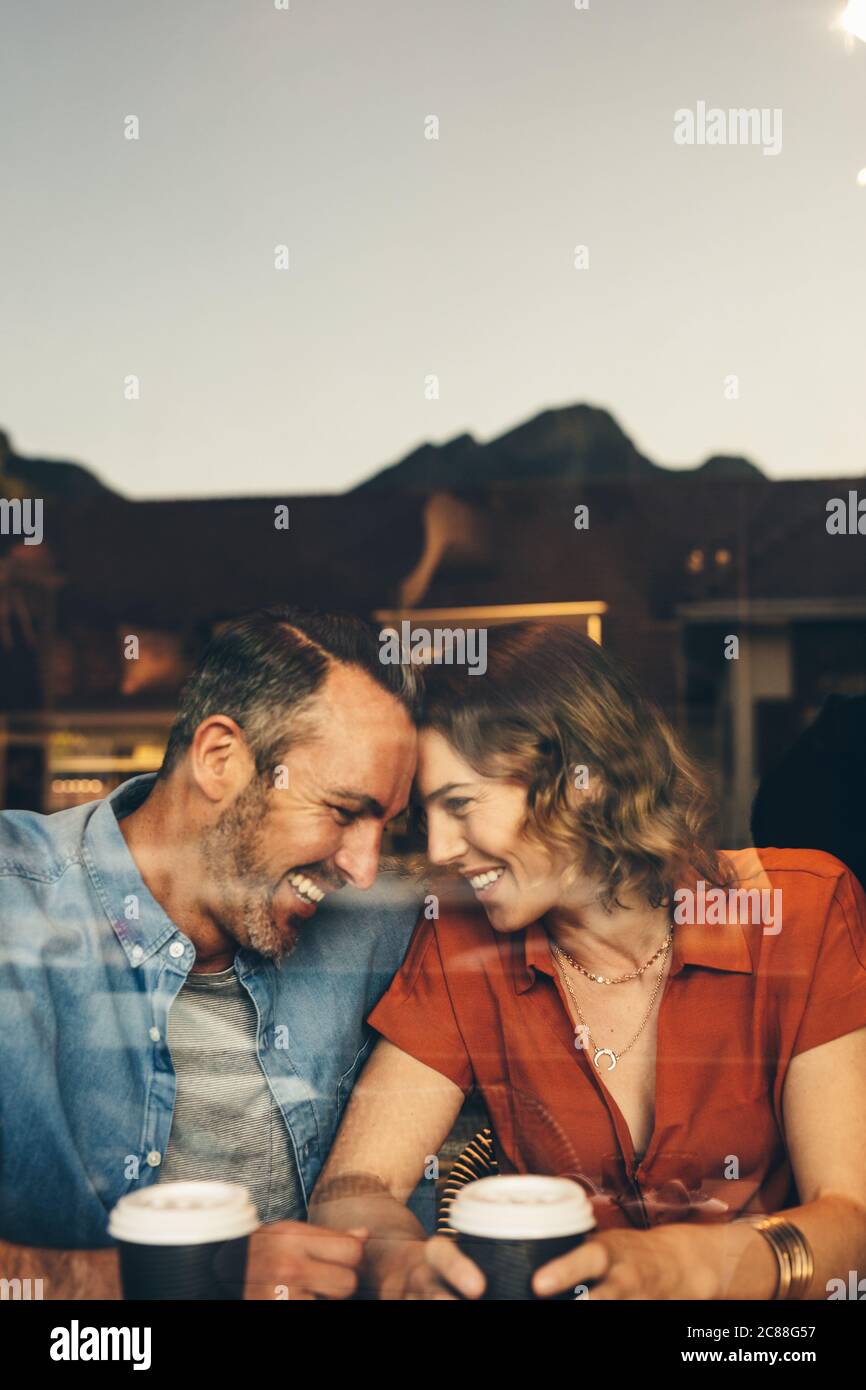 Couple in love on a date. Romantic couple sitting together inside a ...