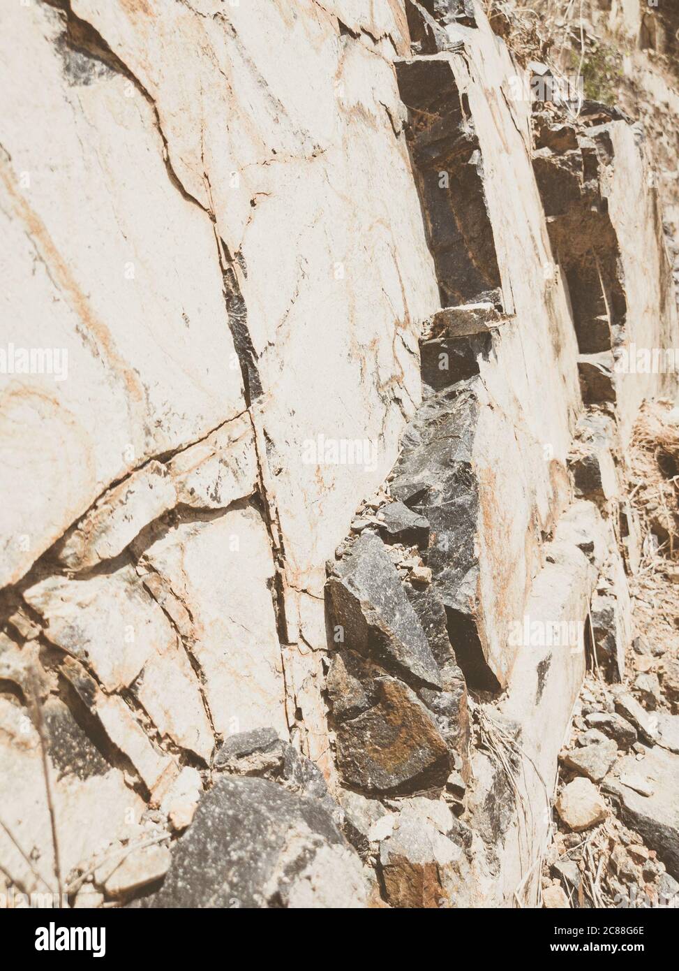Natural background. Closeup edged shabby cliff cracks. Gray-brown stone ...