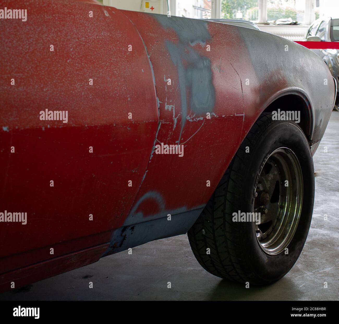 Photo of a muscle car to be restored. Taken from the side. The tire and ...