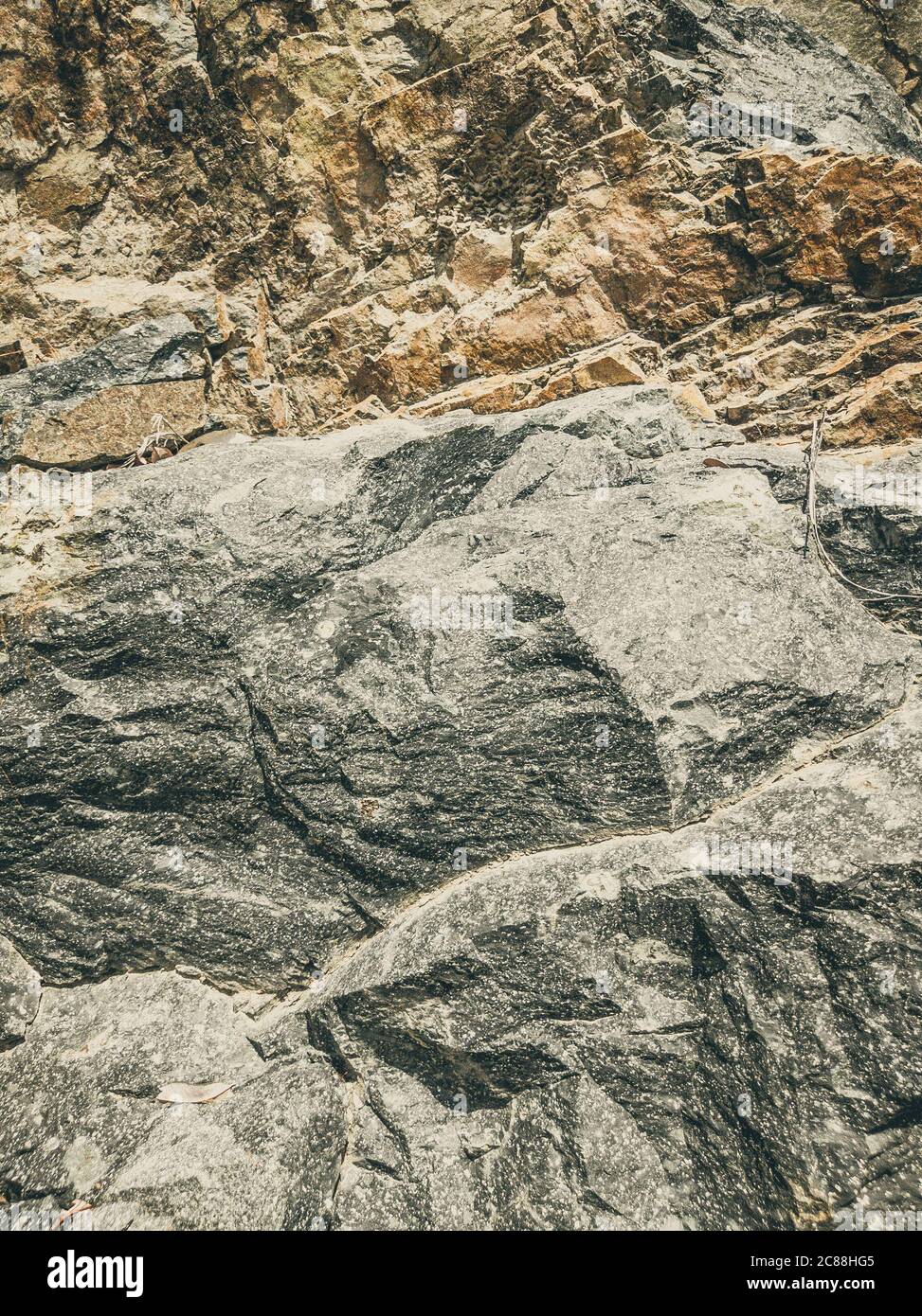 Natural background. Closeup edged shabby cliff cracks. Gray-brown stone ...