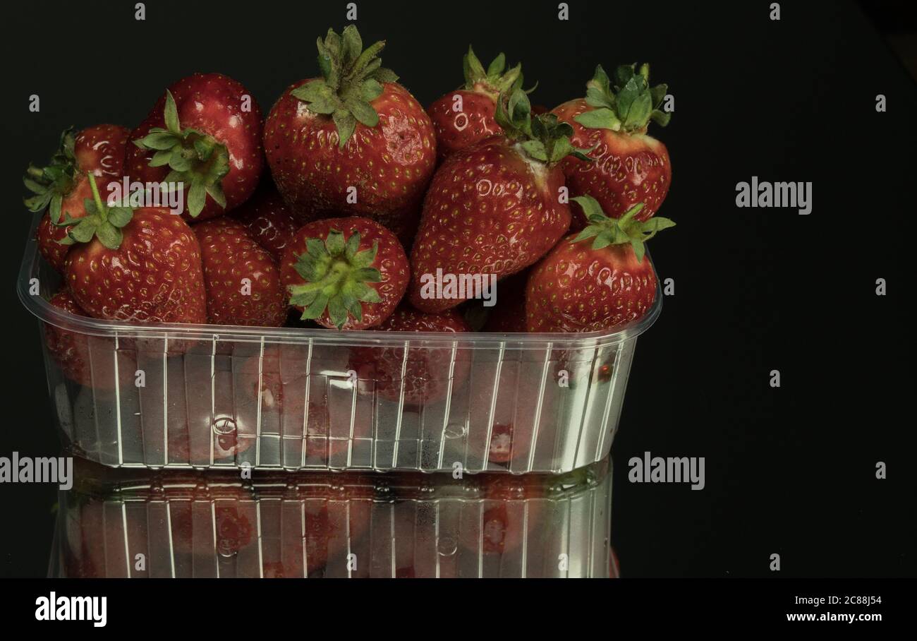 red ripe strawberry in plastic box of packaging Stock Photo - Alamy