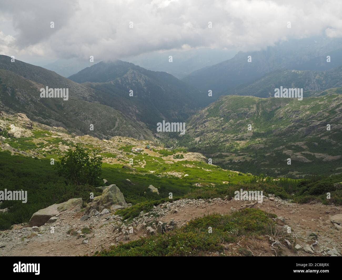 high mountain view scenery with the storm clouds and golden light on ...