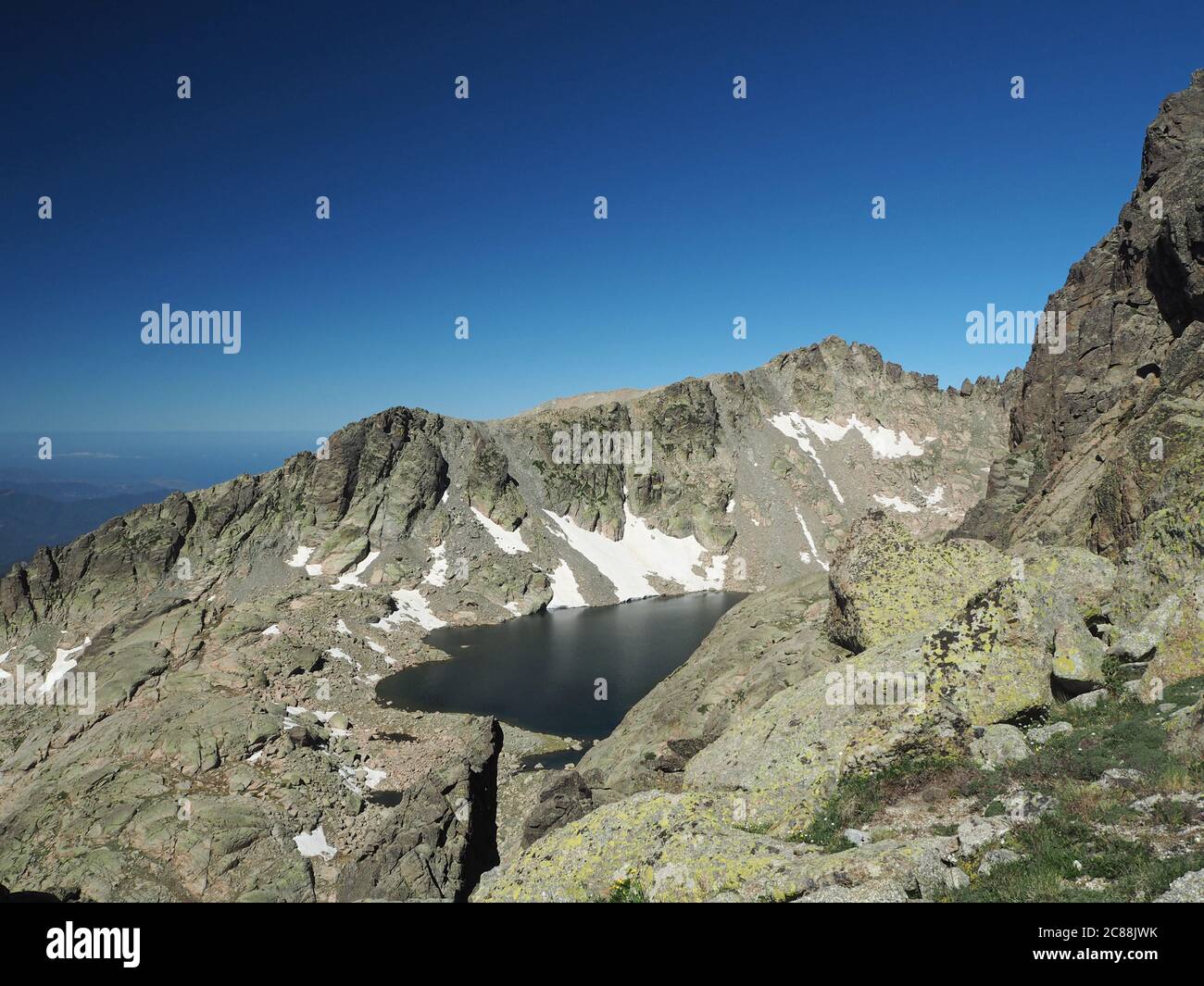 scenery of high mountains with lake snow and sharp peaks Stock Photo ...