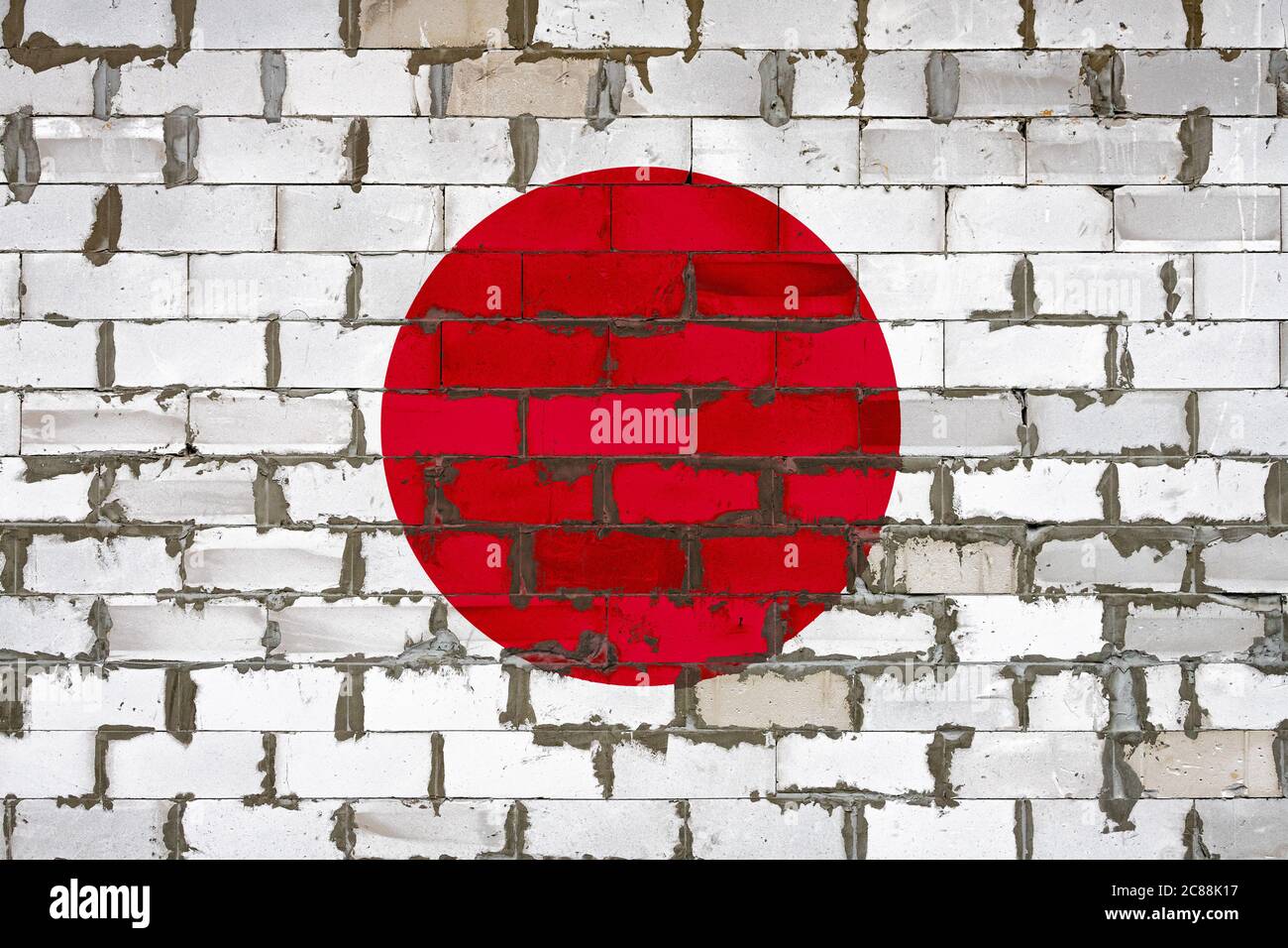 The national flag of Japan painted on a wall of sibit blocks with ...