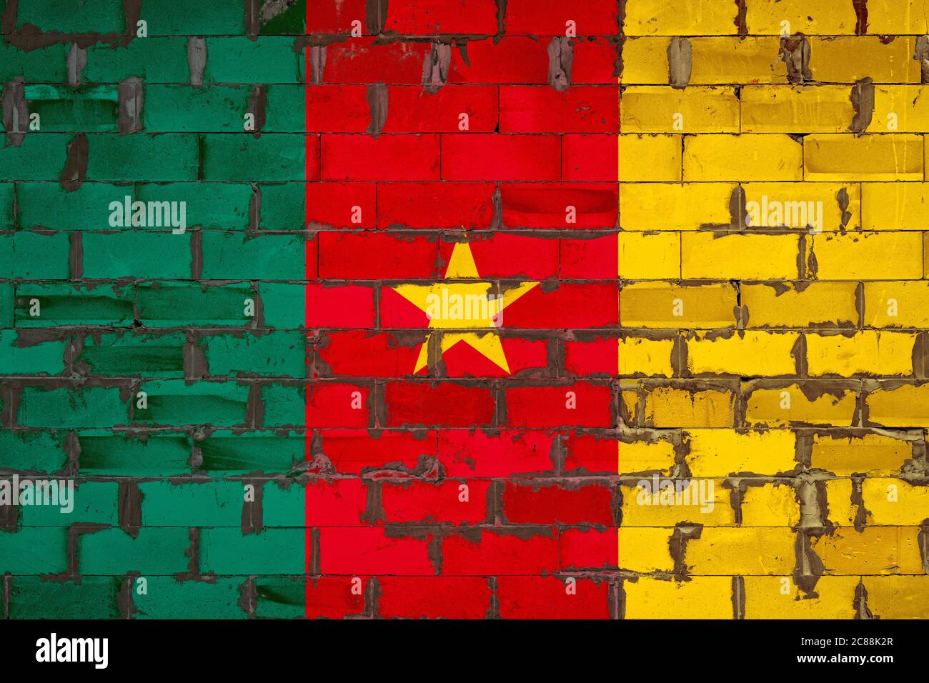 The national flag of Cameroon painted on a wall of sibit blocks with ...