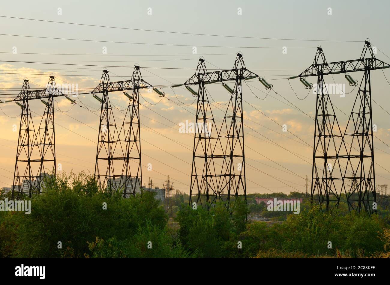 Four high-power support on the sunset sky background Stock Photo - Alamy