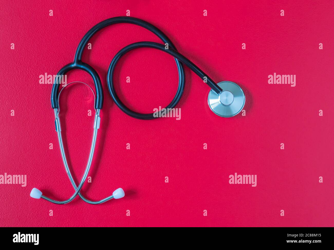 Medical stethoscope on red background with copy space. Flat lay ...