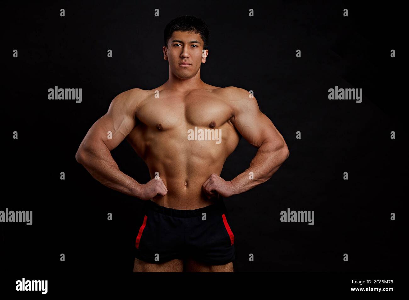 Bare powerful strong man with hands on hips. result of fitness ...