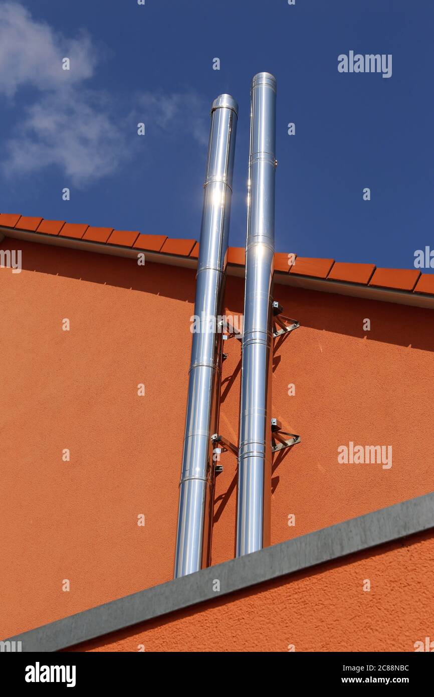 Stainless steel chimney on a new residential home Stock Photo - Alamy