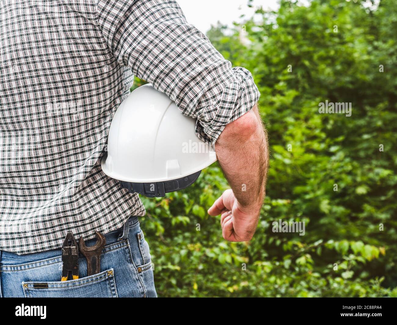 Man with tools, holding a safety helmet Stock Photo - Alamy