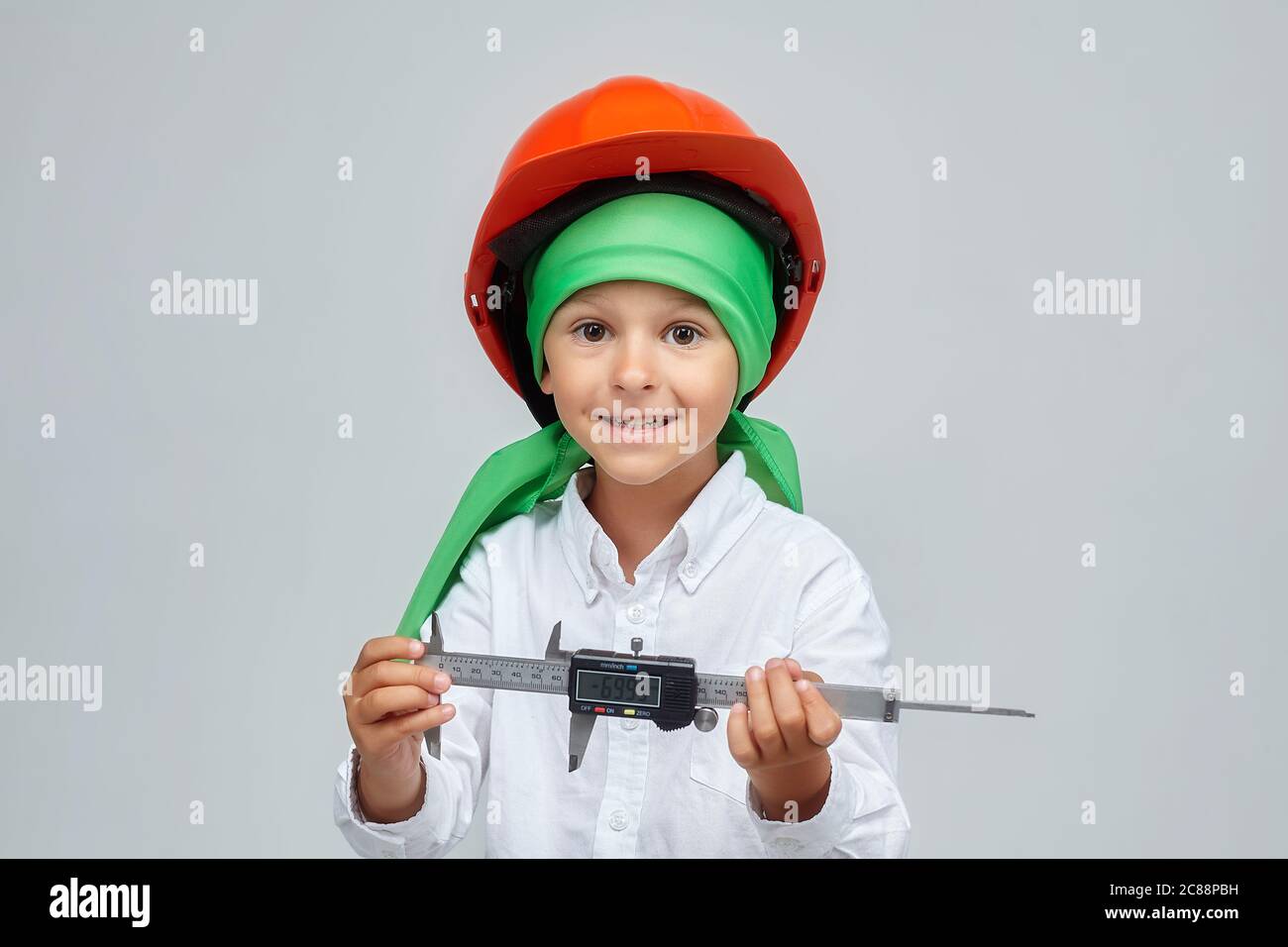 little boy in a construction helmet. shows the caliper. advertising ...