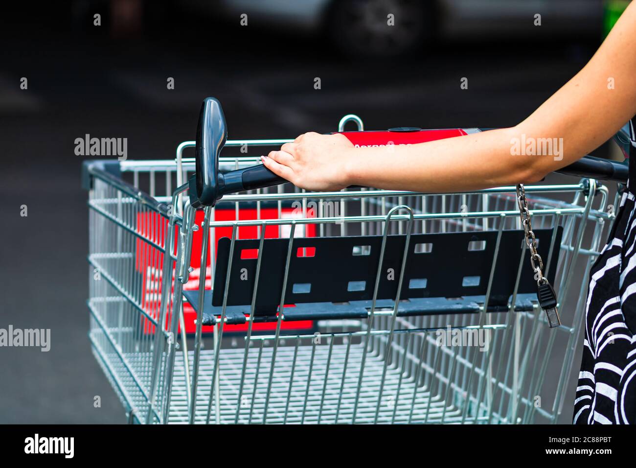 Hands pushing shopping trolley hi-res stock photography and images - Alamy