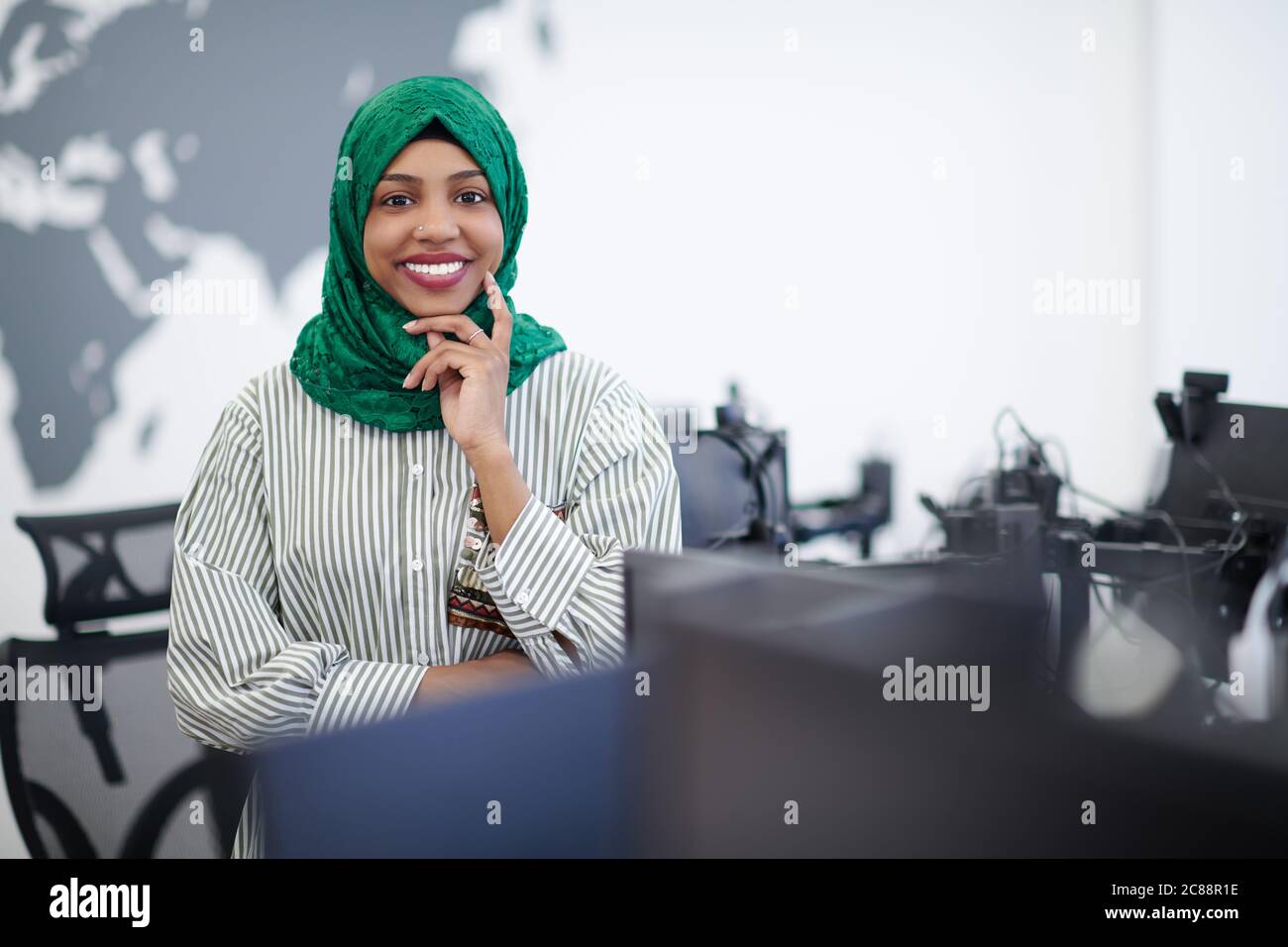 Portrait of muslim african female software developer with green hijab ...