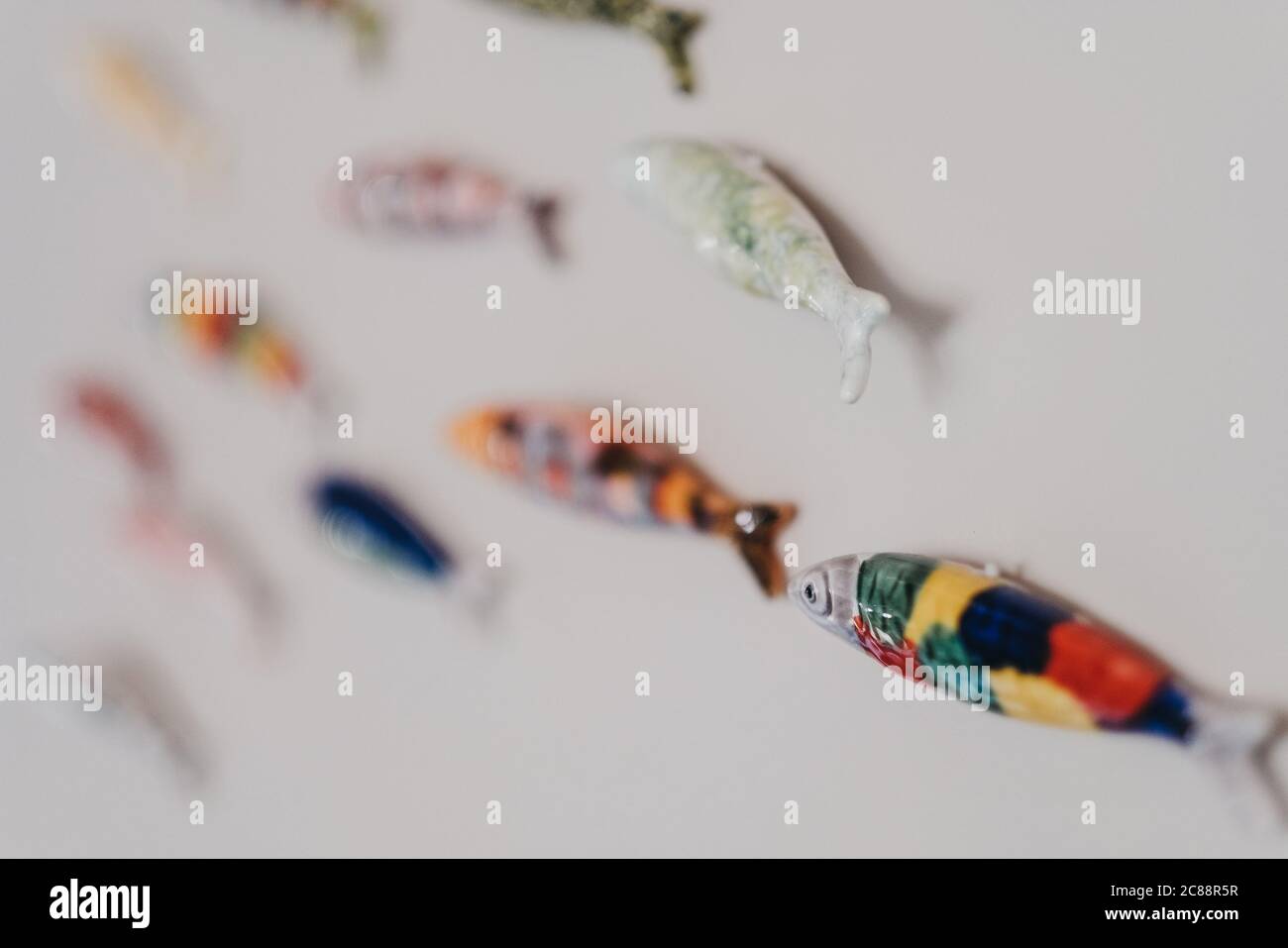 Selective focus shot of fish refrigerator magnets isolated on white ...