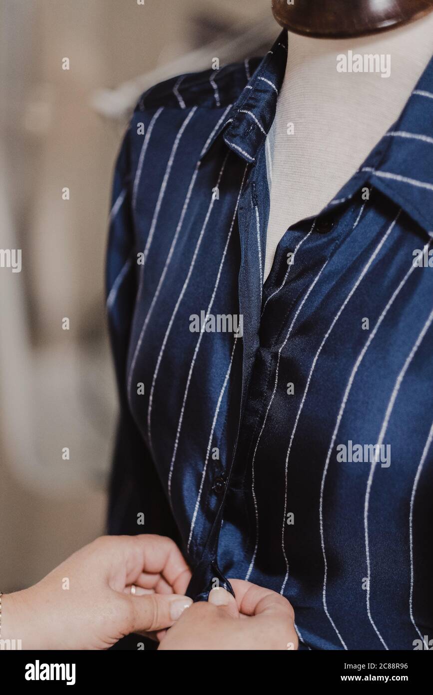 Woman buttoning blouse hi-res stock photography and images - Alamy