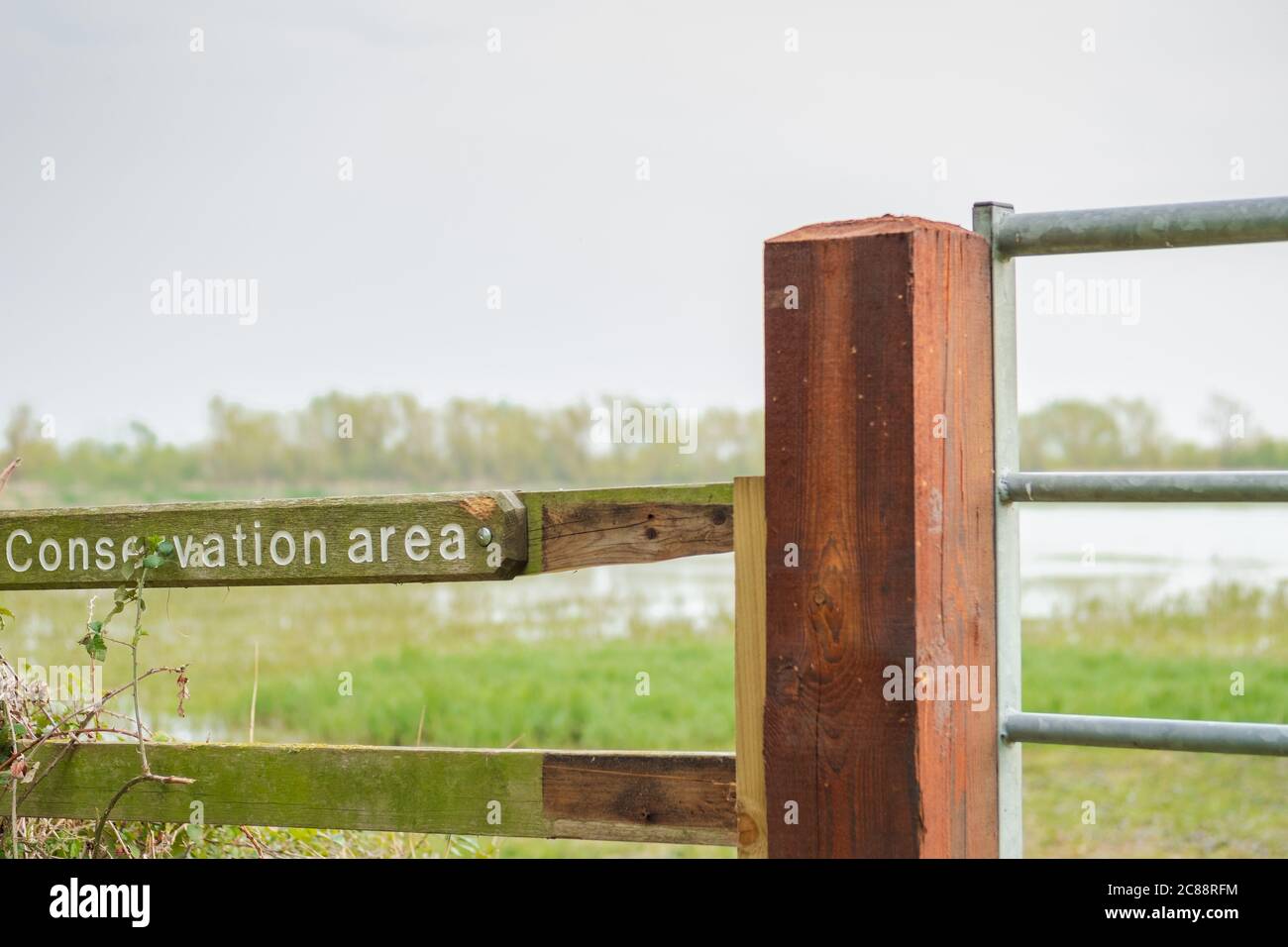 Close-up view of a wooden conservation area sign seen attached near a ...