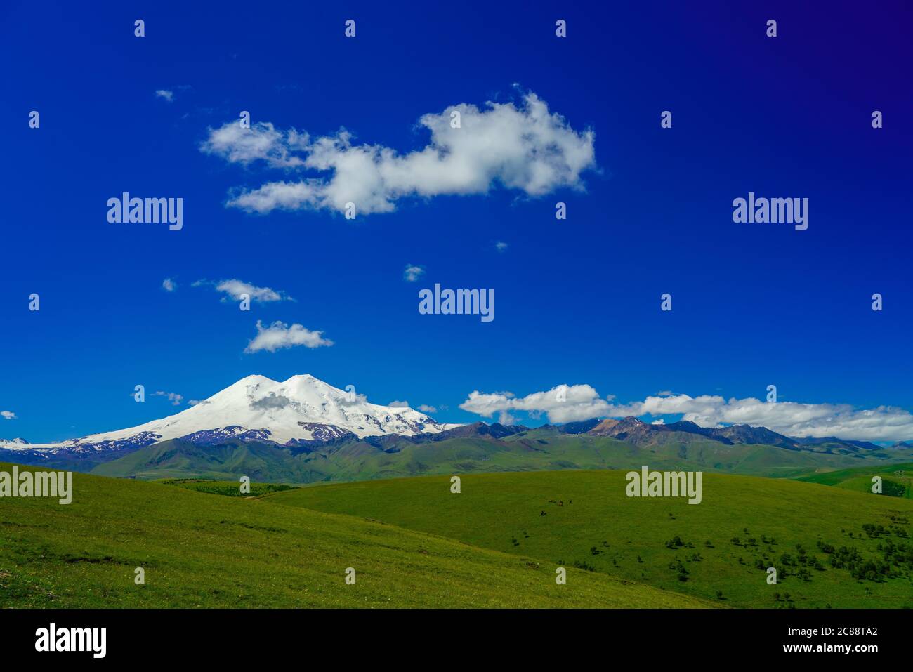 Amazing Elbrus and Green Meadow Hills at a Summer Day. background blue ...