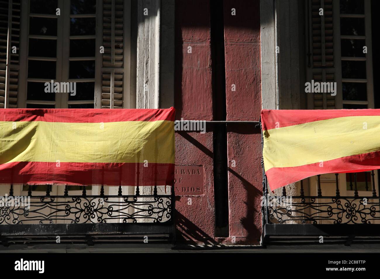 Sunny scenery of building balconies with Spain flags Stock Photo - Alamy