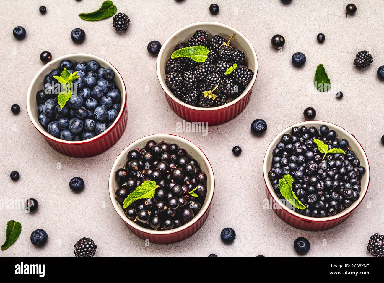 Assorted berries in blue and black colors: bilberry, blueberry, currant ...