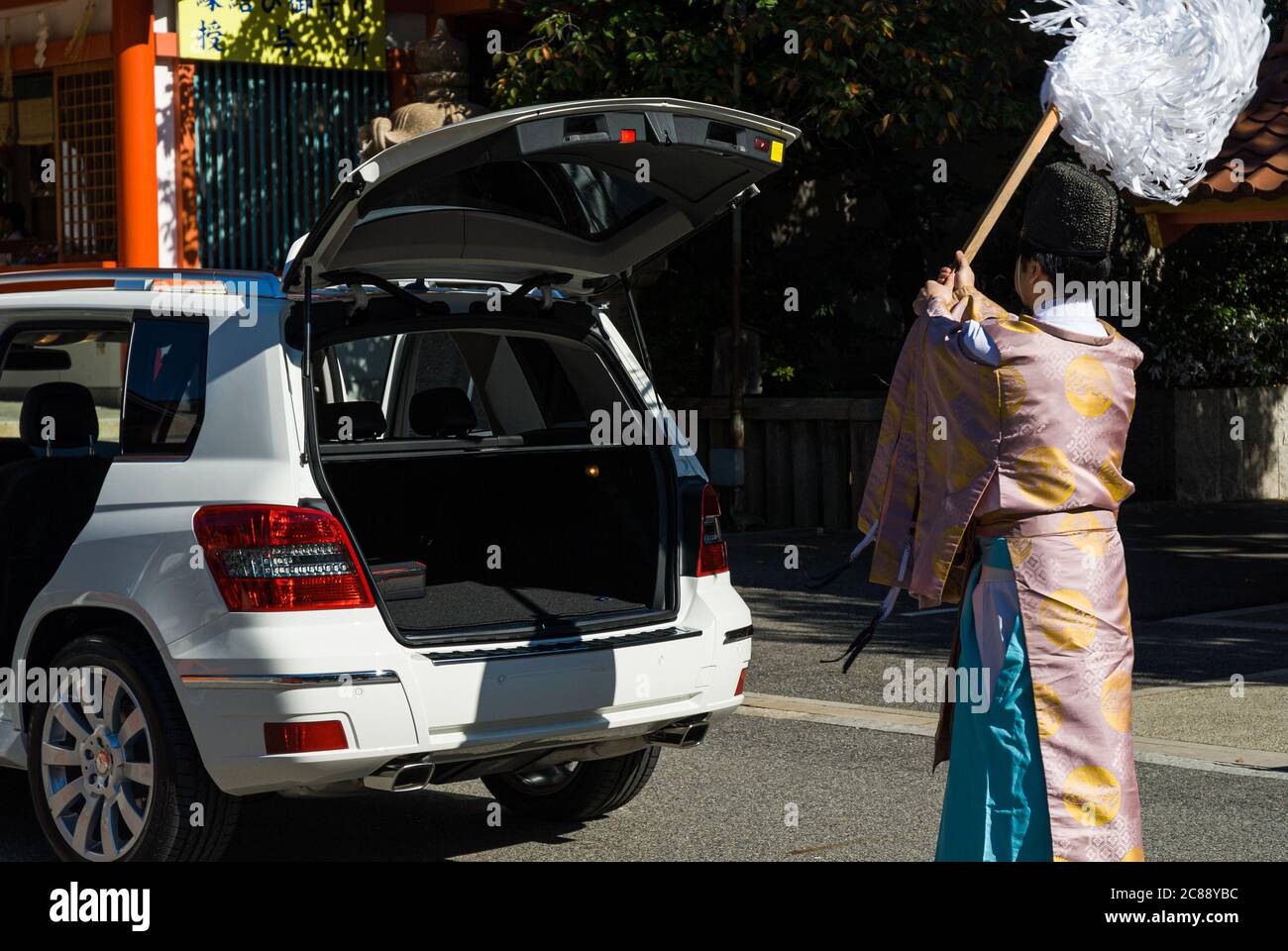 Japanese Shinto priest blessing a new car at Ikuta Shrine, Kobe, Japan ...