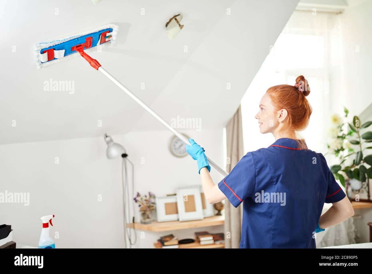 Portrait of young caucasian cleaning lady woman in blue working outfit ...