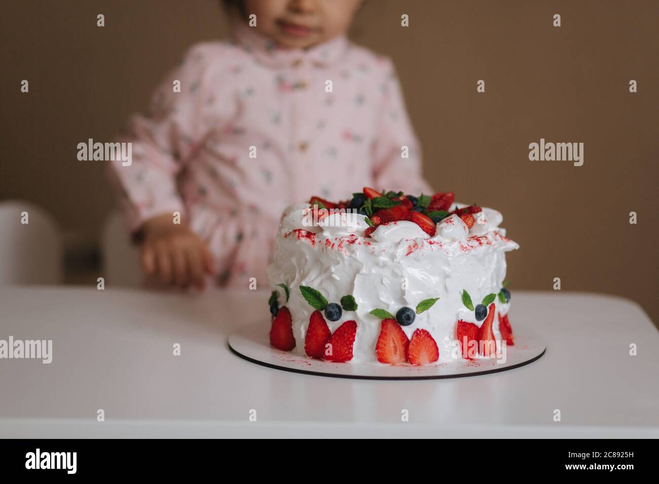 Little girl first time taste bithday cake. Cute little girl in ...