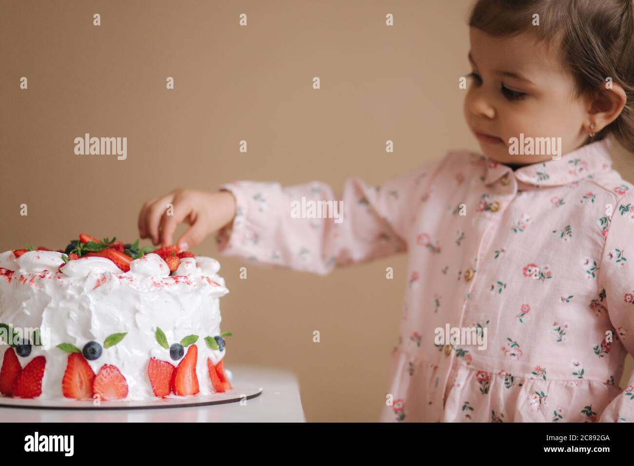 Little girl first time taste bithday cake. Cute little girl in ...