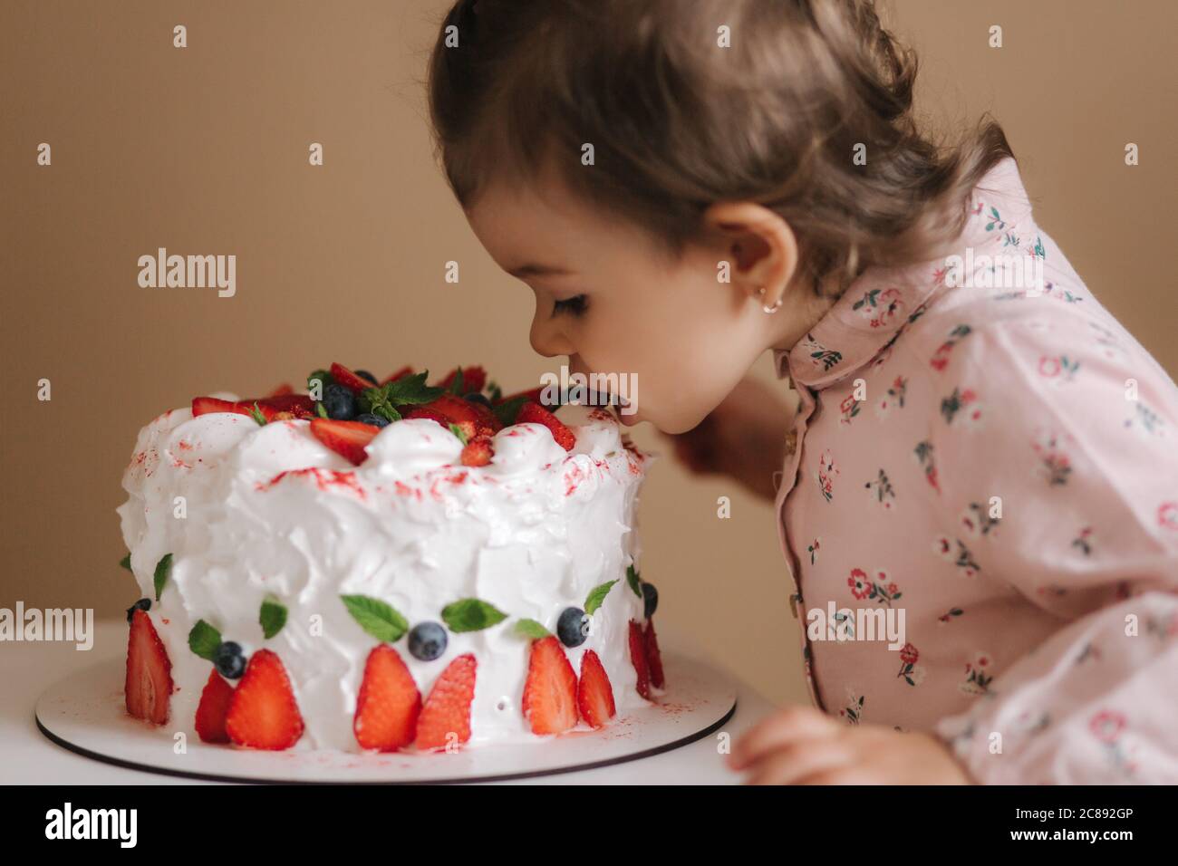 Little girl first time taste bithday cake. Cute little girl in ...