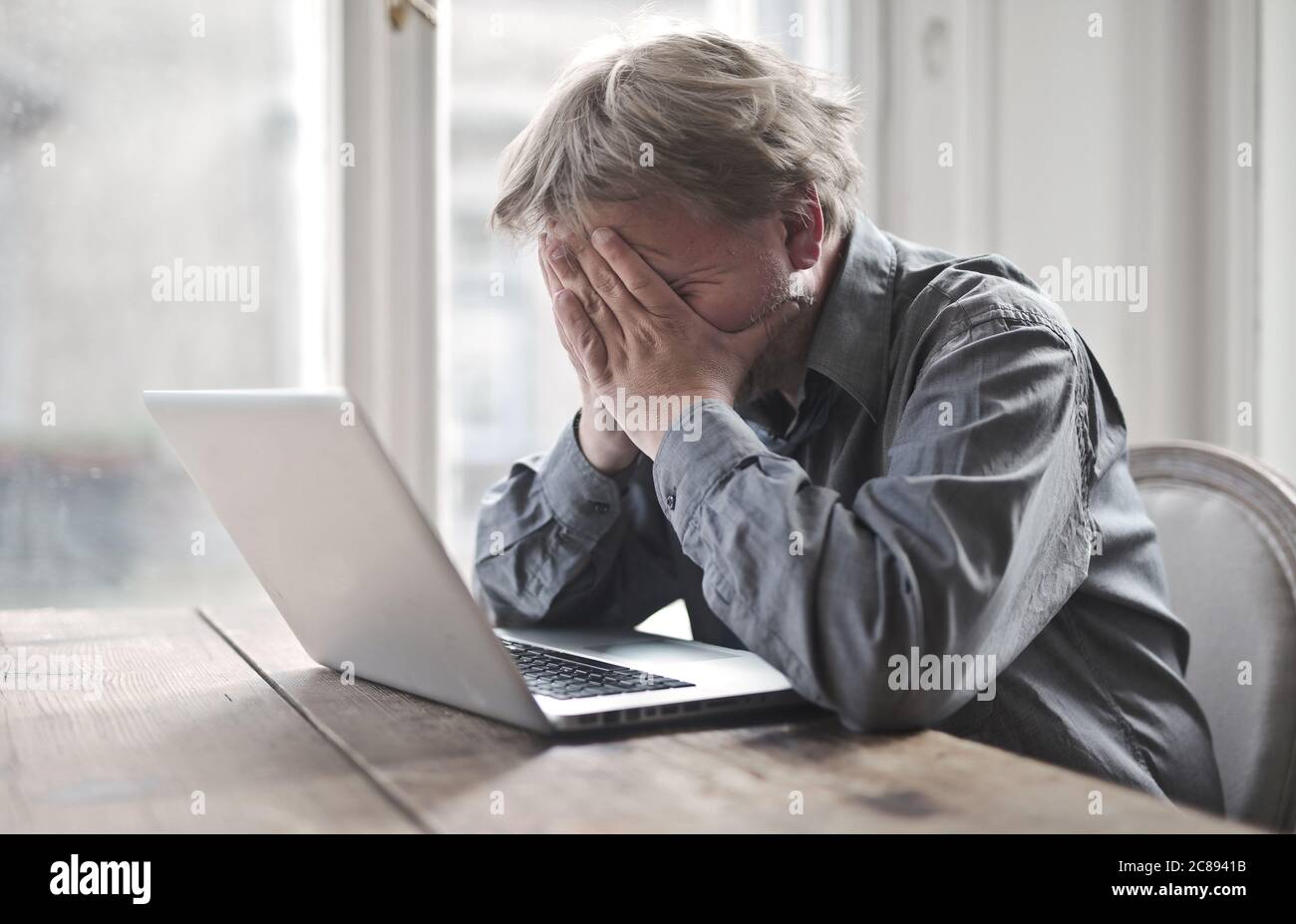Desperate male at the computer Stock Photo - Alamy