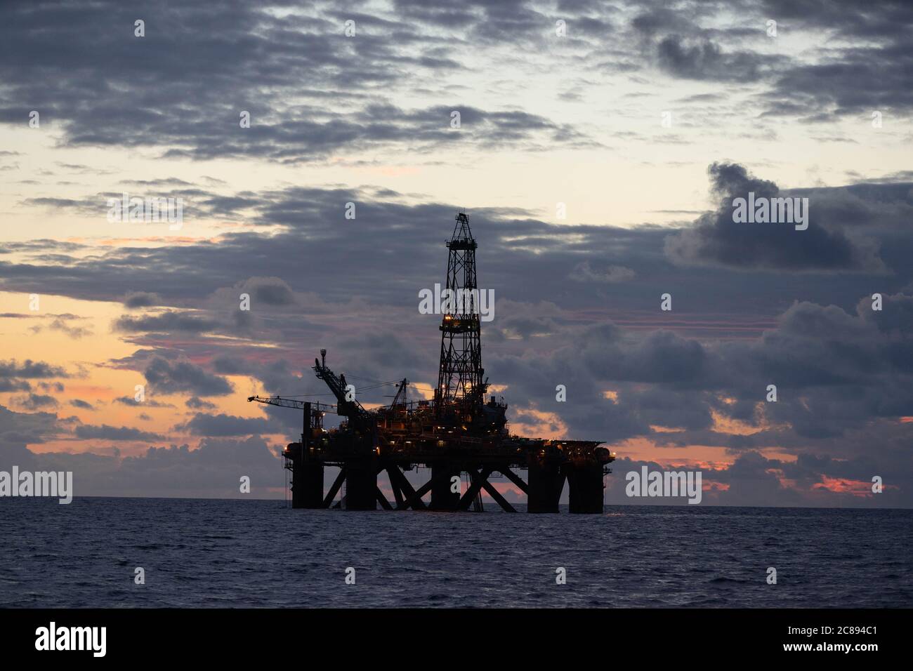 Oil rig at sunset time Stock Photo - Alamy