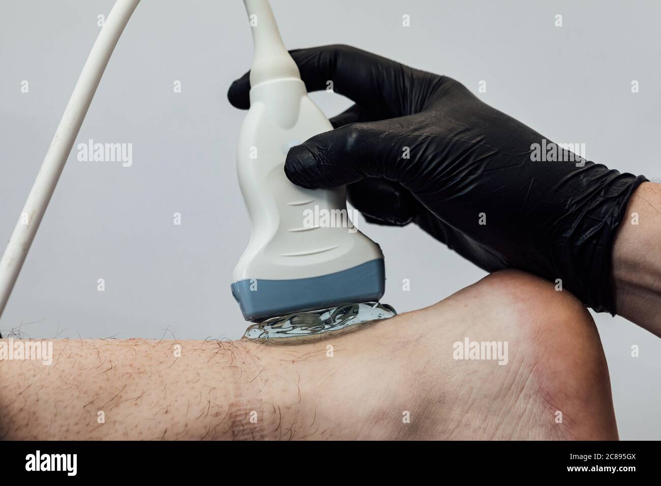 Detail of hand doing an ultrasound scan of the achilles tendon Stock ...