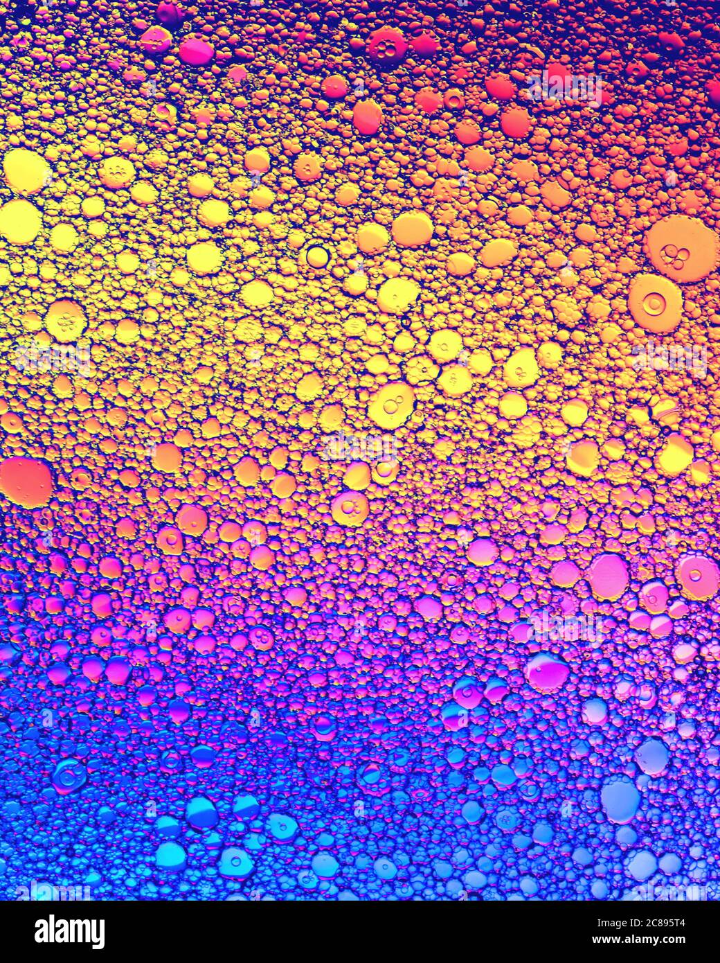 Colorful drops of oil on the water. Rainbow or spectrum colored circles ...