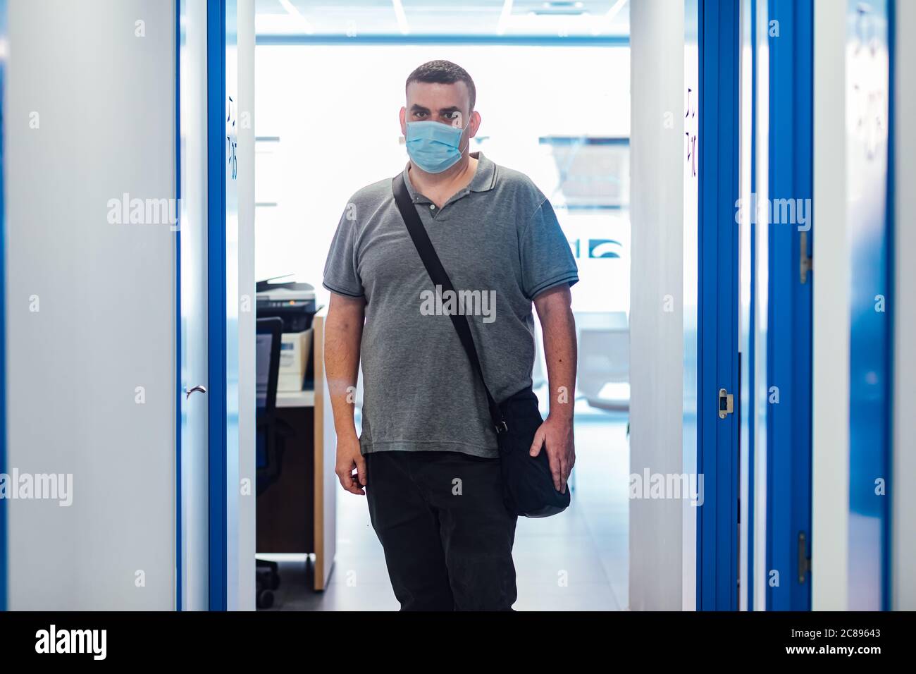 Chubby patient wearing face mask leaving a medical consultation Stock ...