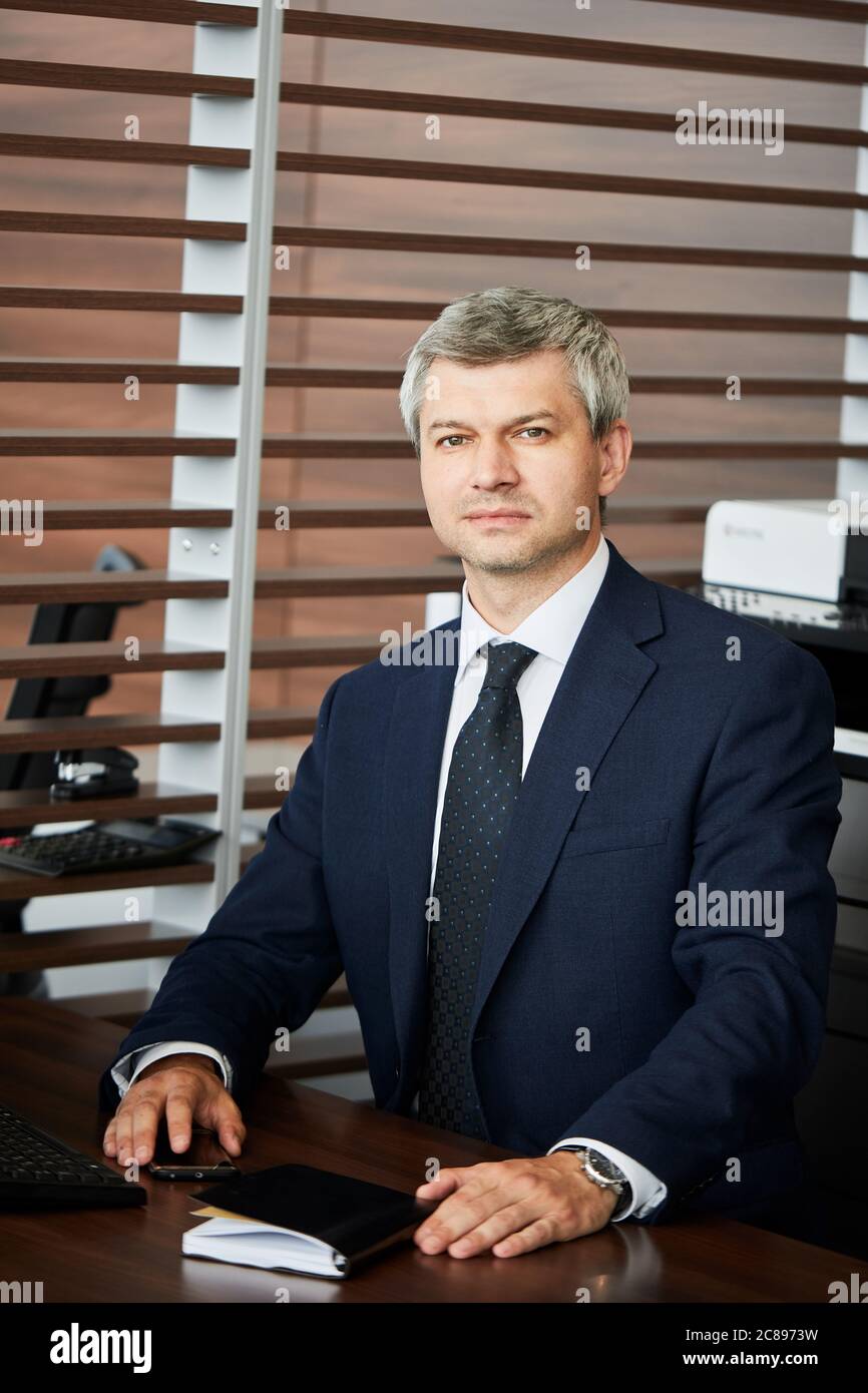 Portrait of caucasian confident businessman in classy suit at his ...